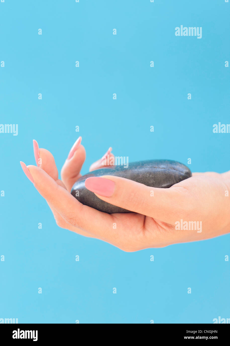 Stone in a woman's hand Stock Photo - Alamy