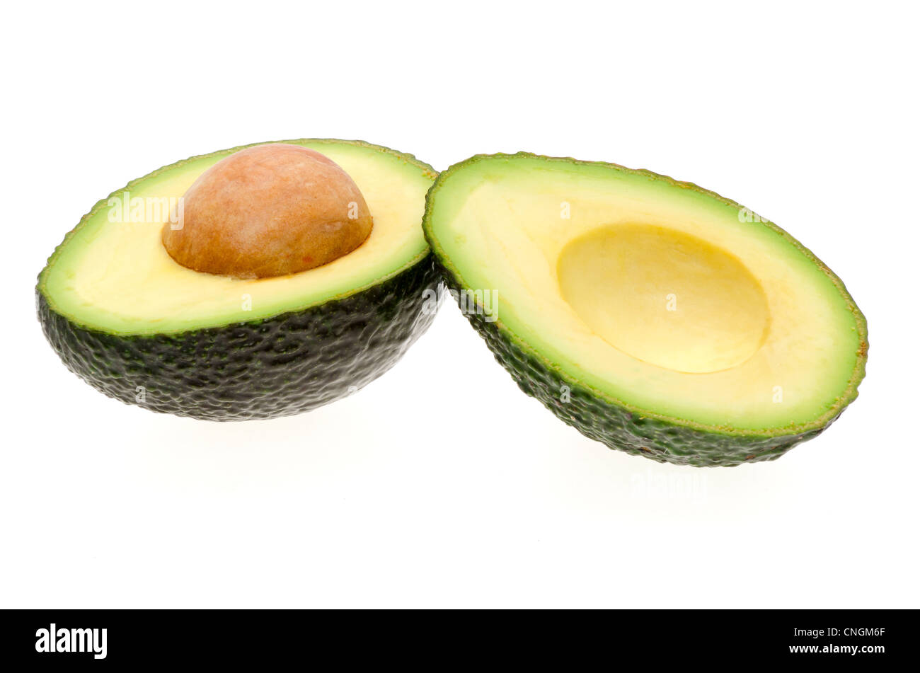 A whole avocado cut in half - shot in the studio with a white ...