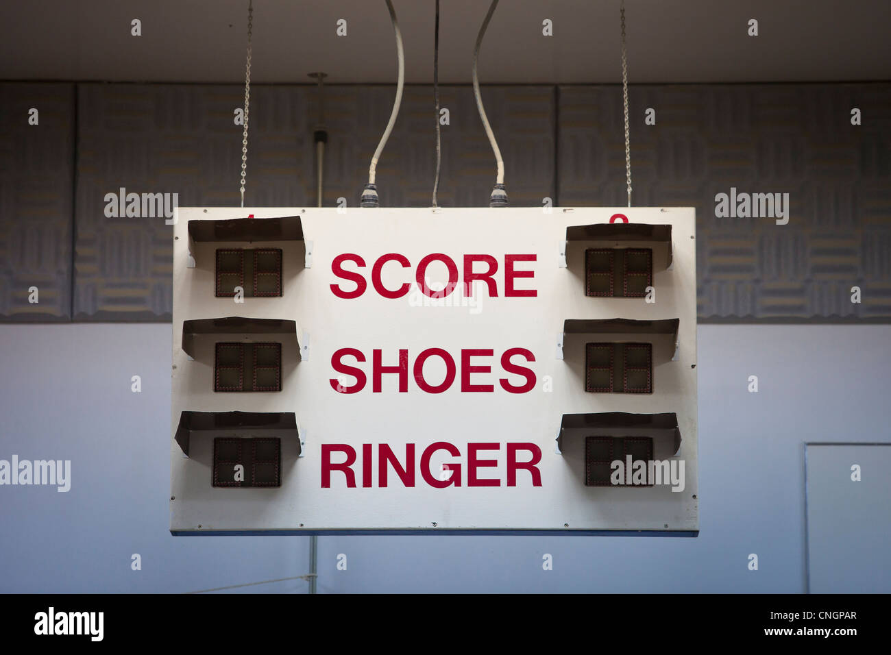 A horseshoe tournament scoreboard hangs from the ceiling Stock Photo ...