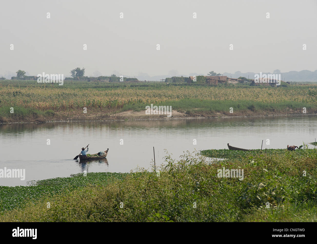 Fisherman in boat on Ayeyarwady river, between Mandalay and Sagaing ...