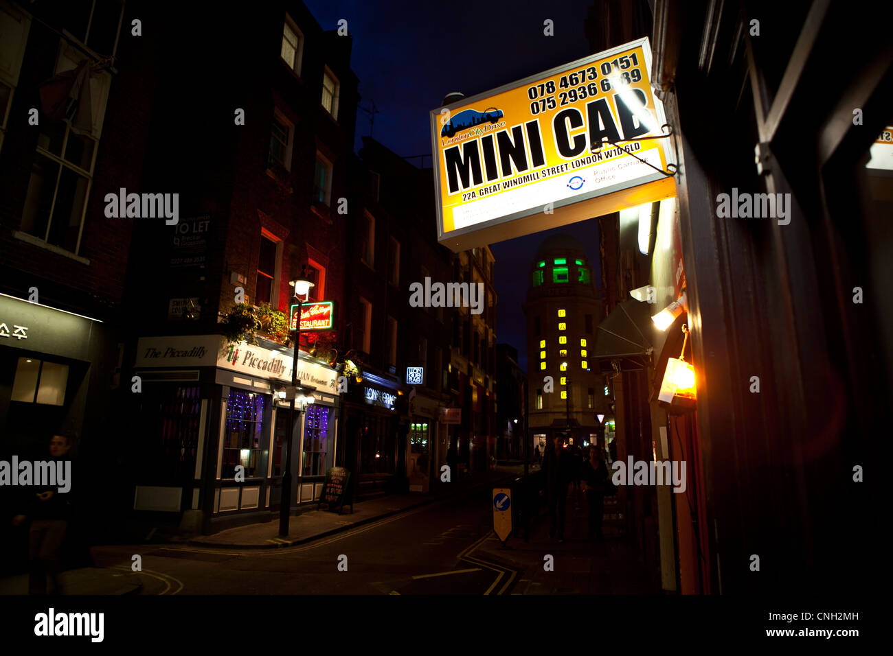 Mini Cab office sign at night Stock Photo - Alamy