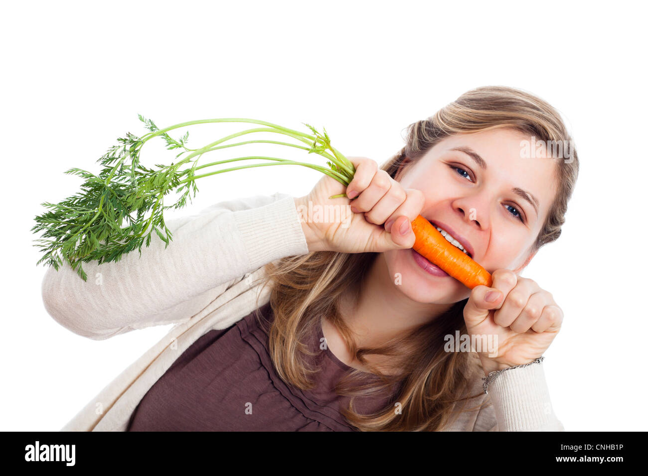Young beautiful funny woman biting fresh carrot, isolated on white ...