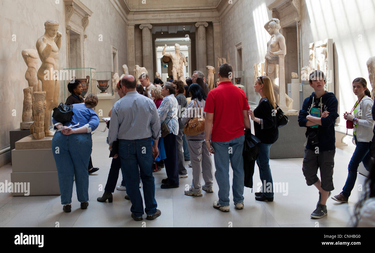 Visitors to the Metropolitan Museum of Art listen to a tour guide in ...