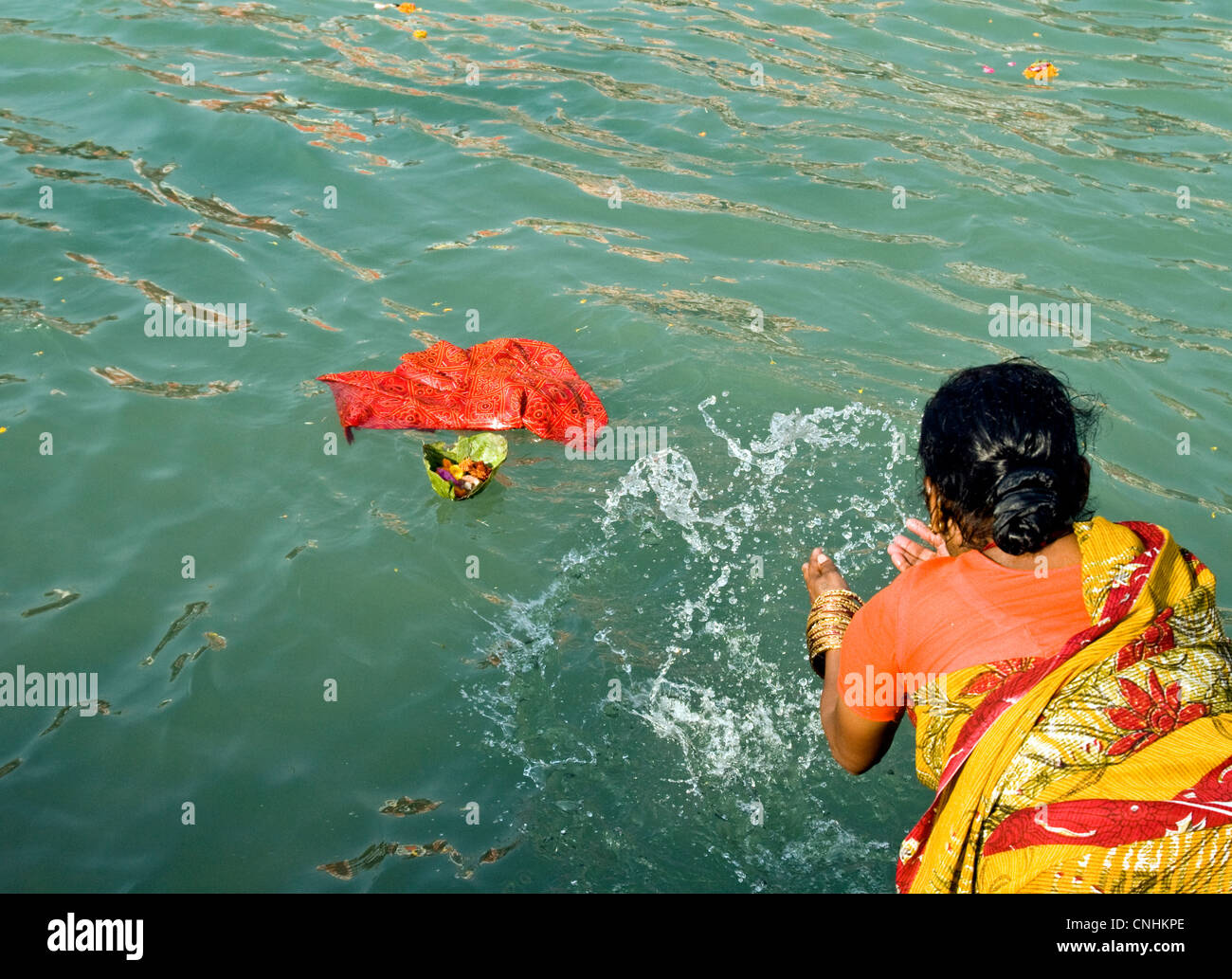 Woman praying a the holy Ganges river ,during Kumbh mela 2010, Haridwar ...