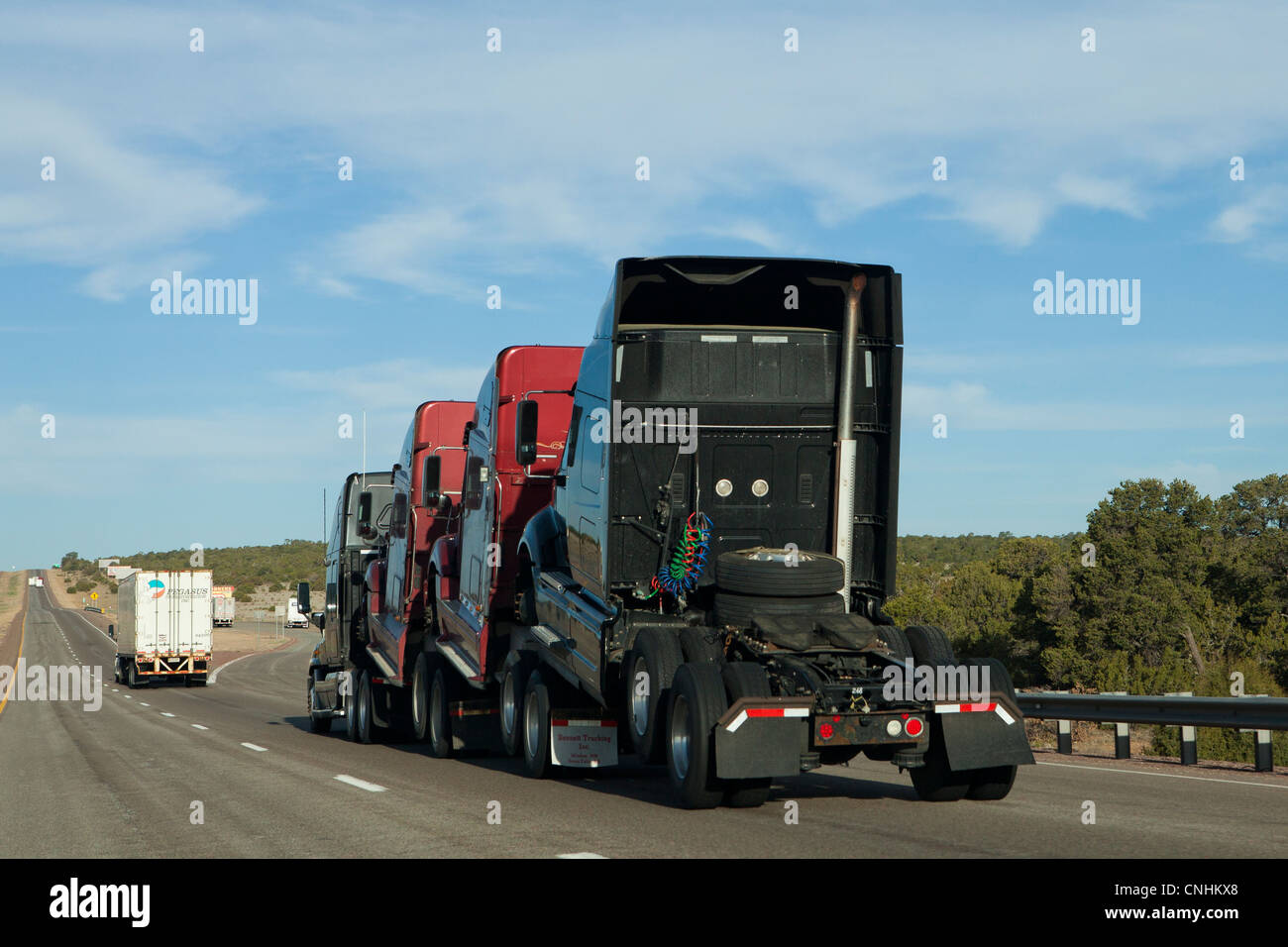 One truck towing three trucks Stock Photo - Alamy