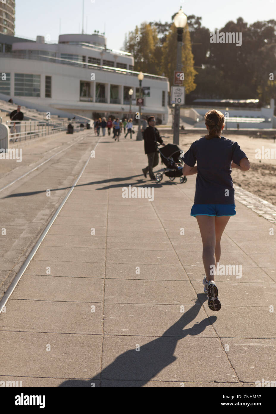 A young female jogging in late afternoon Stock Photo - Alamy