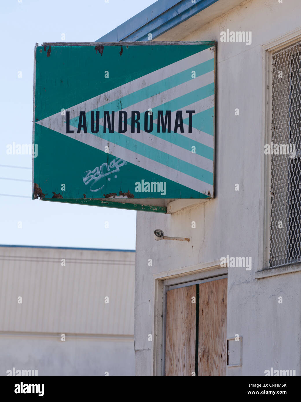Old, worn laundromat sign Stock Photo - Alamy