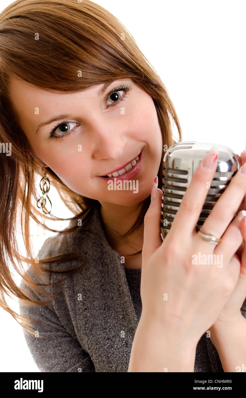 Young woman holding a retro-microphone. Isolated on white Stock Photo ...