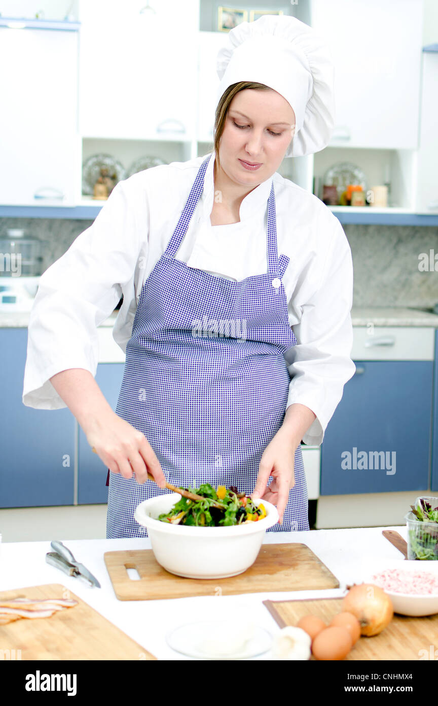 Attractive chief cook preparing salad Stock Photo - Alamy