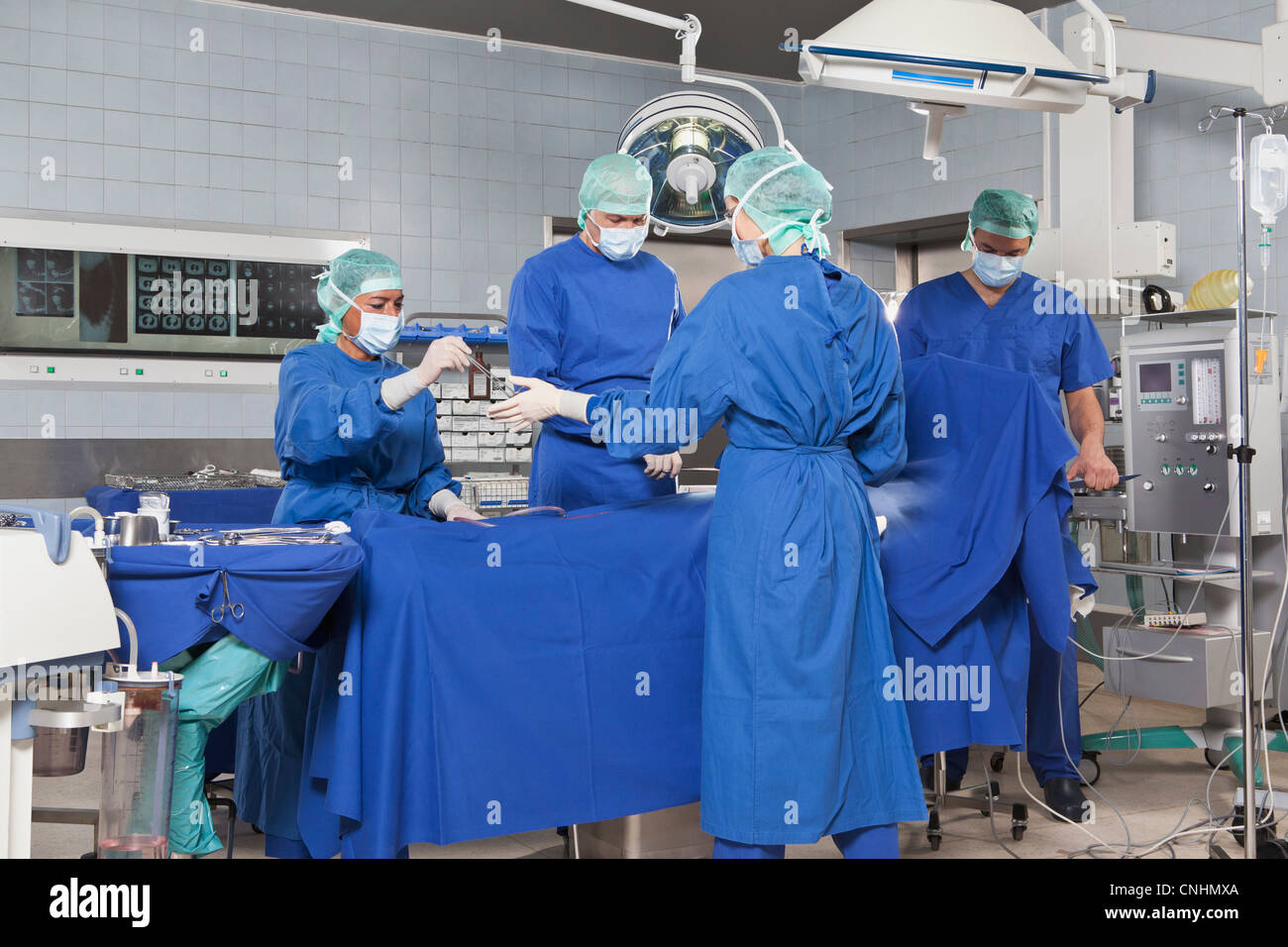 A surgery team operating on a patient in an operating room Stock Photo ...