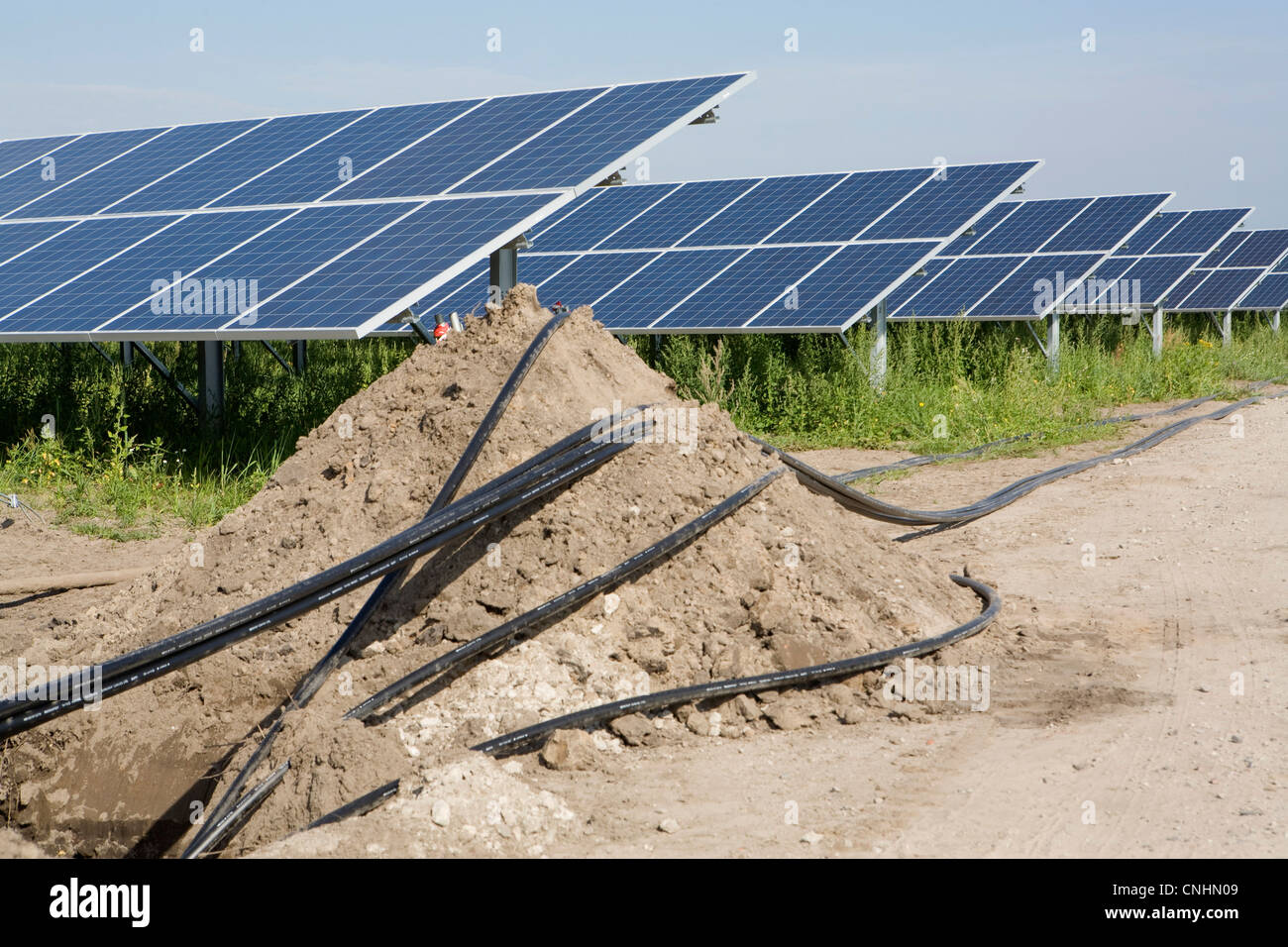 Detail of pipes and solar panels being installed in a field Stock Photo ...