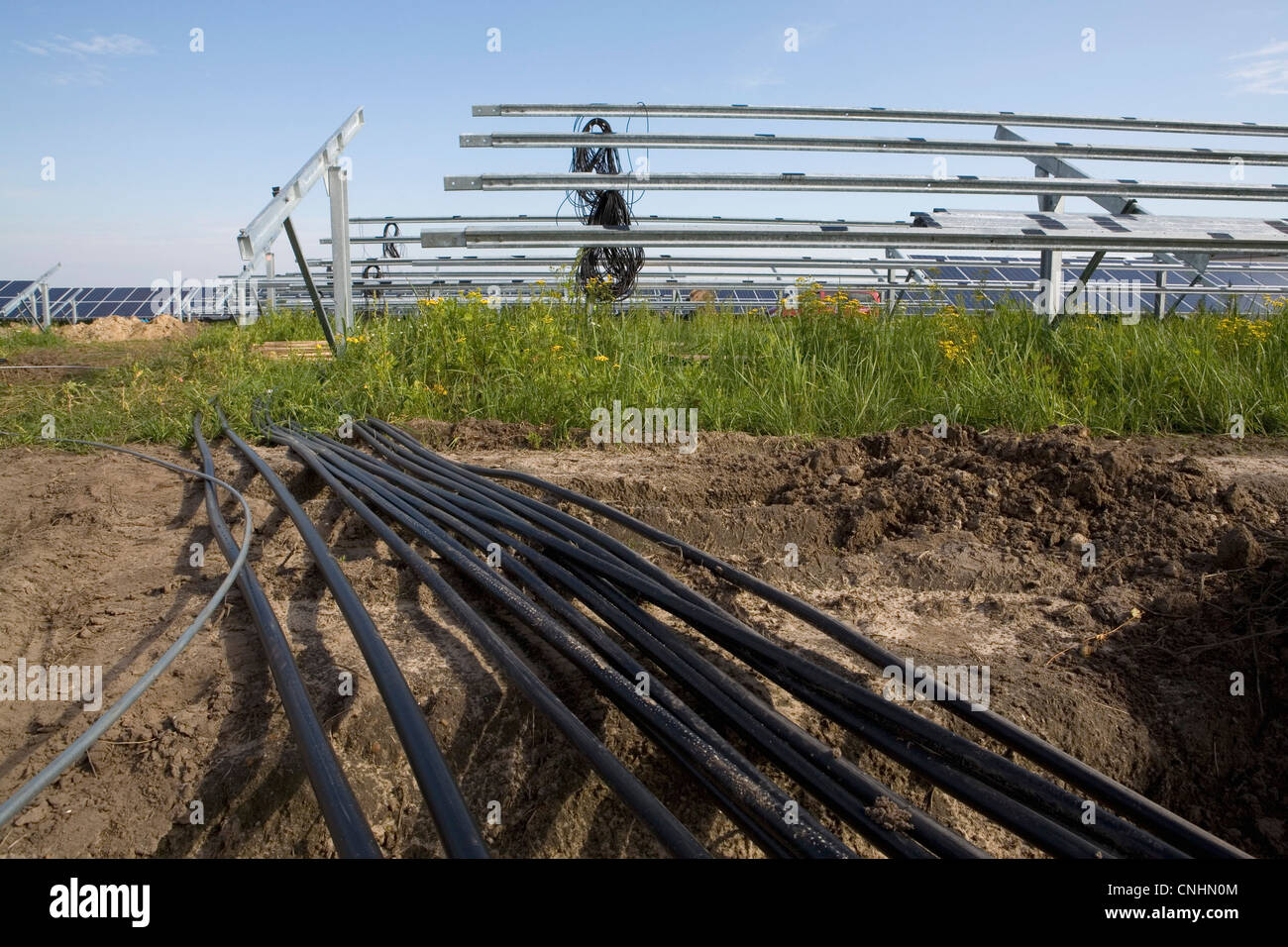Detail of pipes and solar panels being installed in a field Stock Photo ...