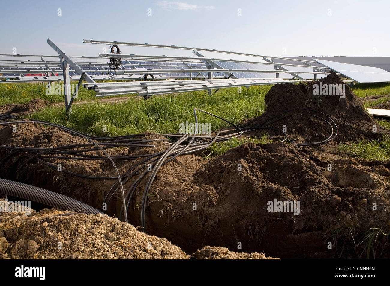 Installation of pipes and solar panels in a field Stock Photo - Alamy