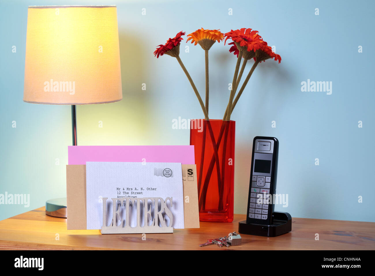 Photo of a letter rack with mail on a hall table Stock Photo - Alamy