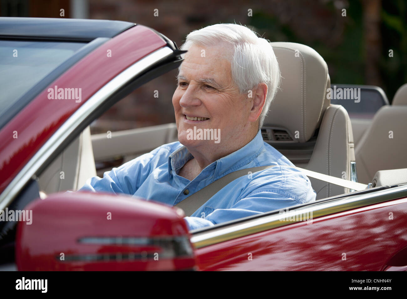 Senior man driving red sports hi-res stock photography and images - Alamy