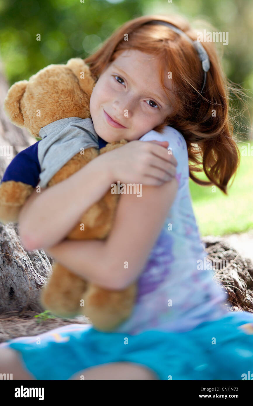 Girl hugging teddy bear Stock Photo - Alamy