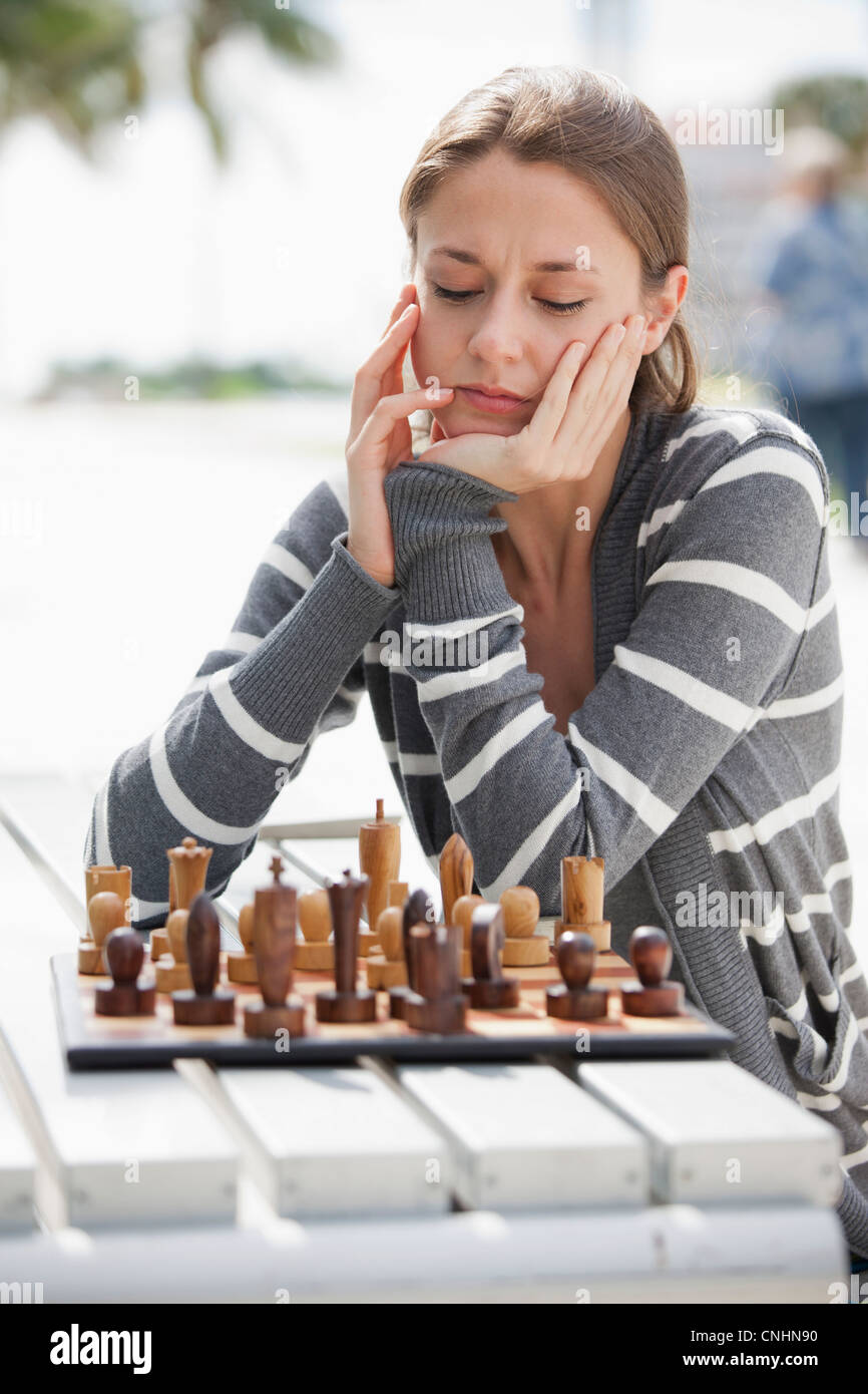 Girl plays chess outside Stock Photo - Alamy