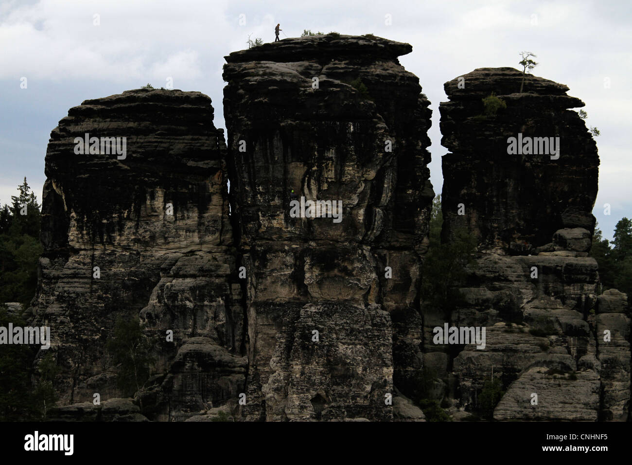 A person climbing a rock formation, Saxon Switzerland, Saxony, Germany ...