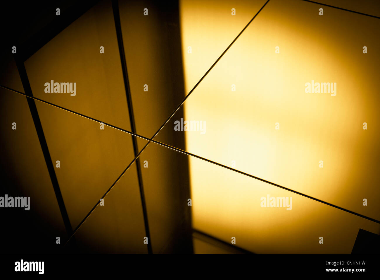 Close-up spot lit reflection in yellow toned mirrors Stock Photo - Alamy
