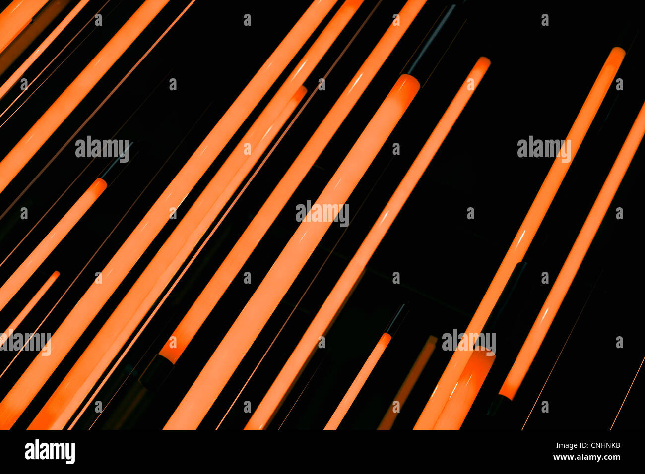 Neon orange rods of glowing light Stock Photo - Alamy