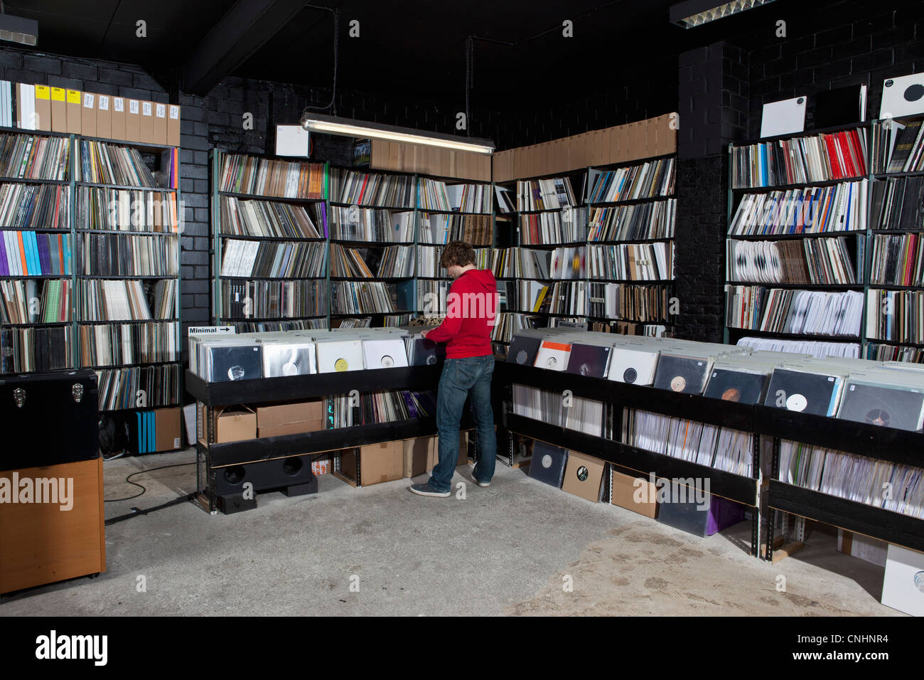 A young man searching through records, rear view Stock Photo - Alamy