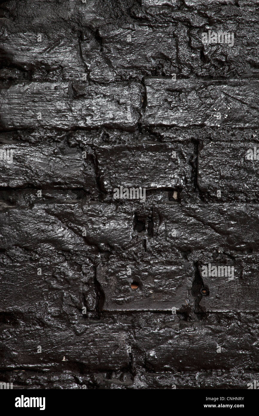 A brick wall painted black, full frame Stock Photo - Alamy