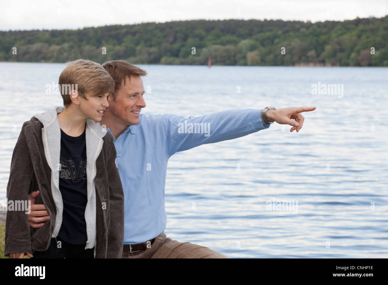 A father pointing something out to his son, outdoors Stock Photo - Alamy