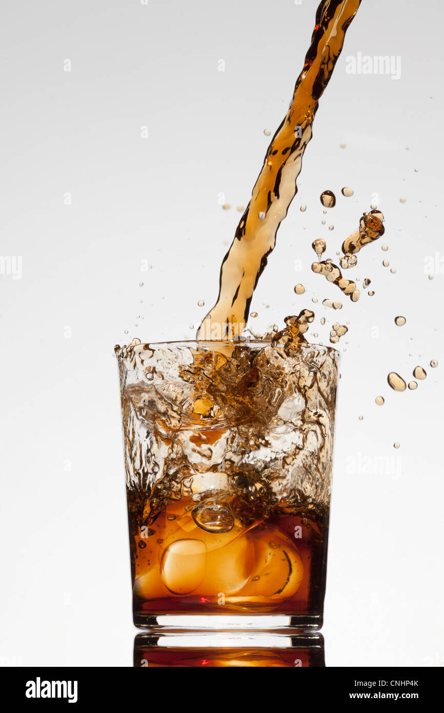 A drink being poured into a glass Stock Photo - Alamy