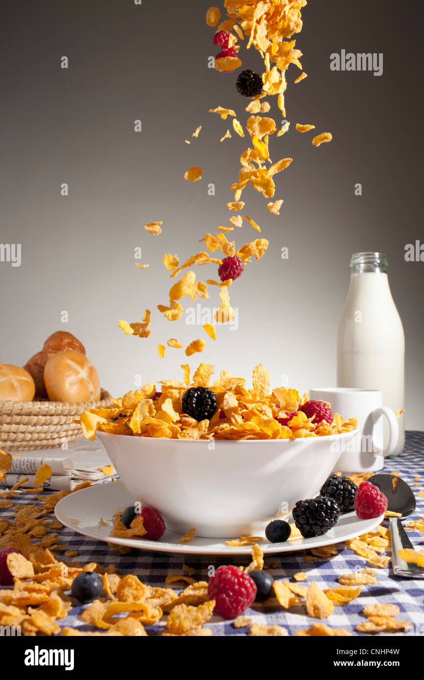 Flakes of cereal and milk being poured into a bowl hi-res stock ...
