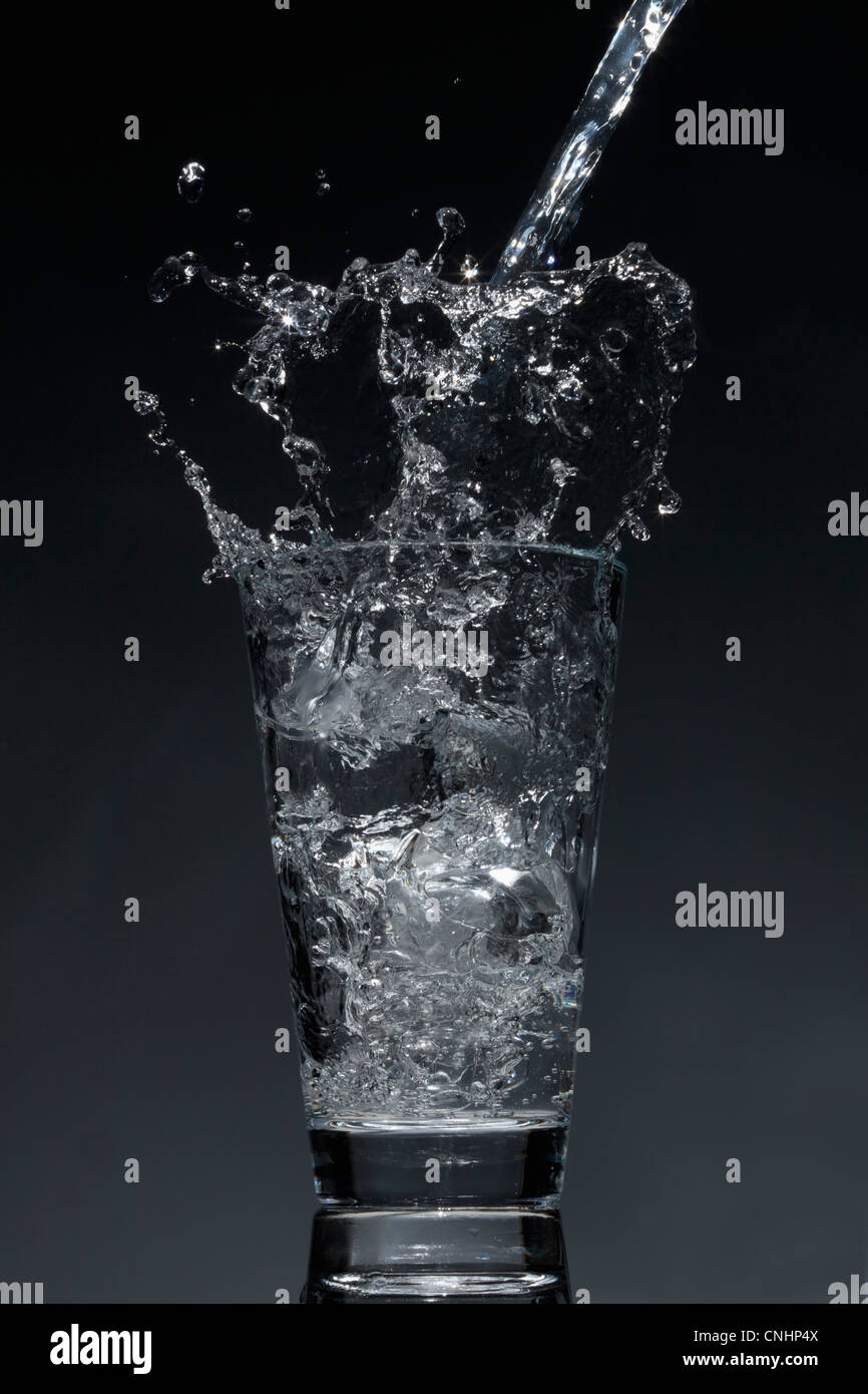 Water being poured into a glass Stock Photo - Alamy