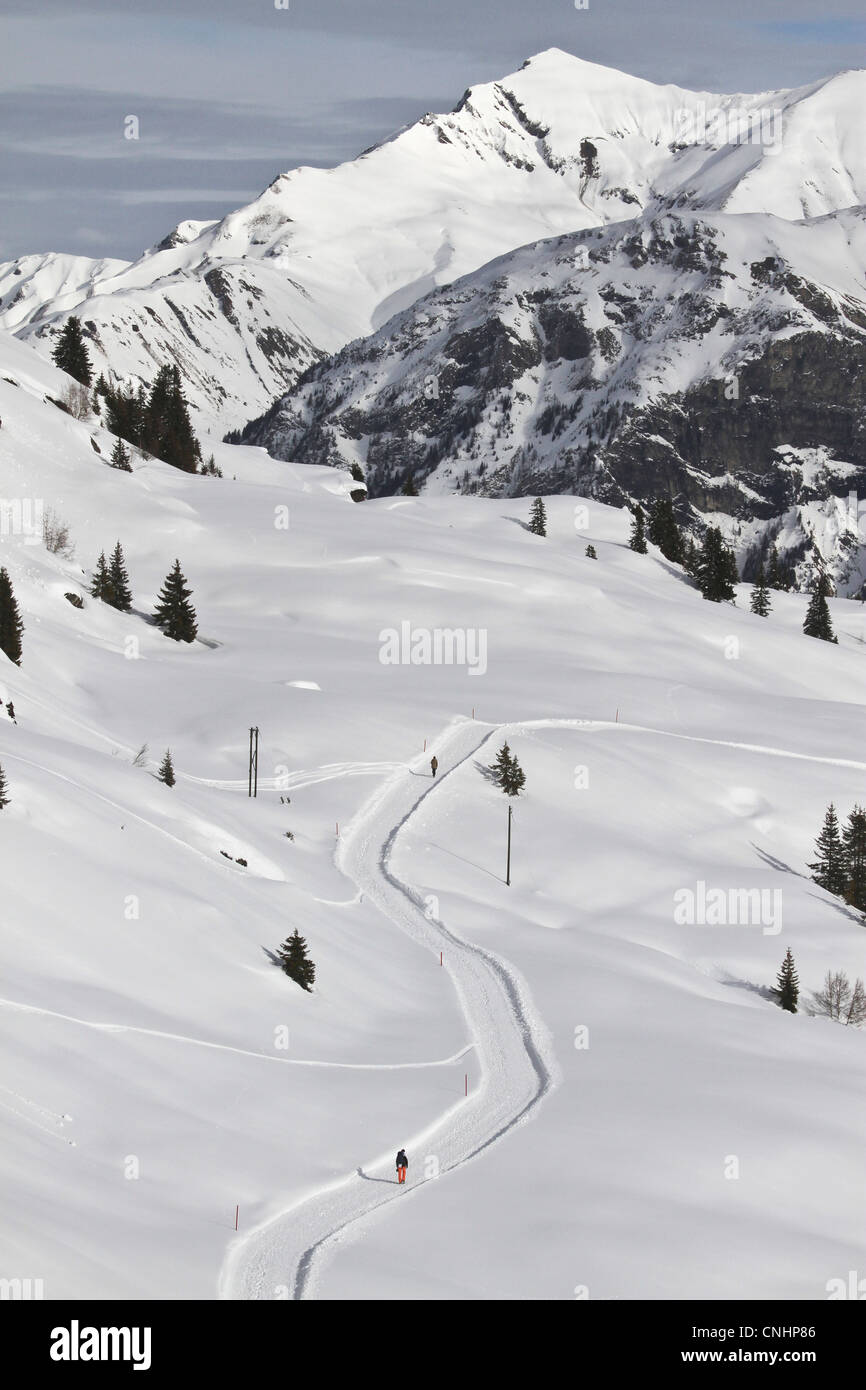 Snow path and mountain range in background Stock Photo - Alamy