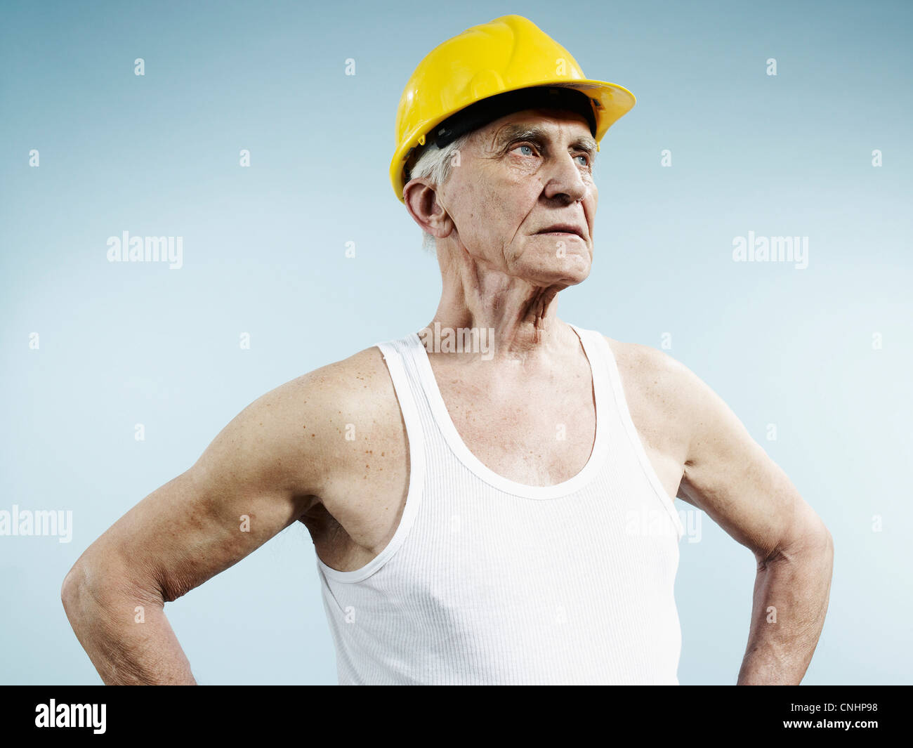A senior man wearing a hardhat and tank top Stock Photo - Alamy