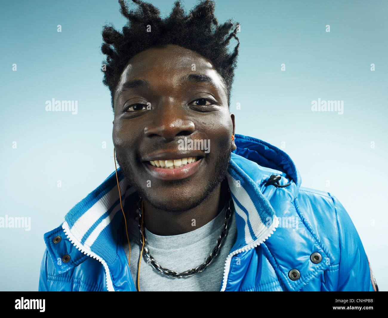 A young man wearing a vintage ski jacket and earbuds Stock Photo - Alamy