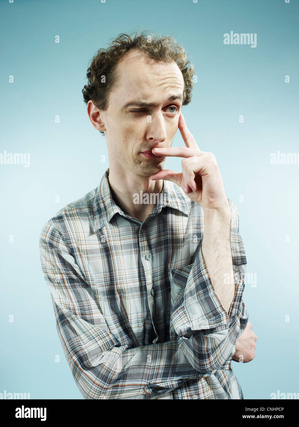 A man with an expression of uncertainty, looking away Stock Photo - Alamy