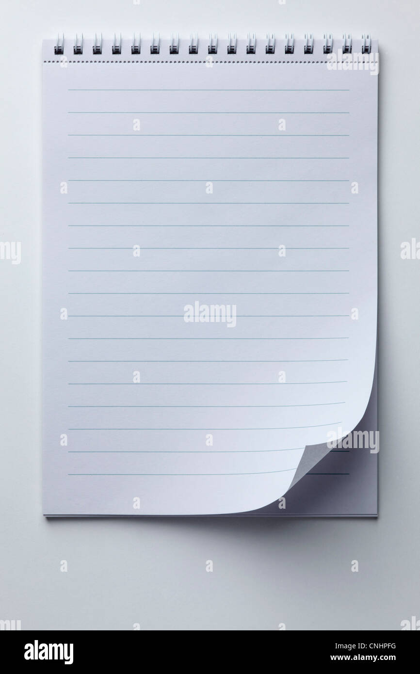 A spiral notepad with lined paper and a curled up page corner Stock ...