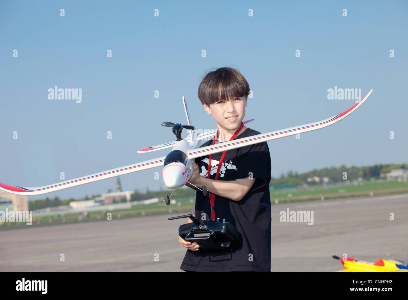 Boy with model airplane at the abandoned airfield at Tempelhof Airport ...
