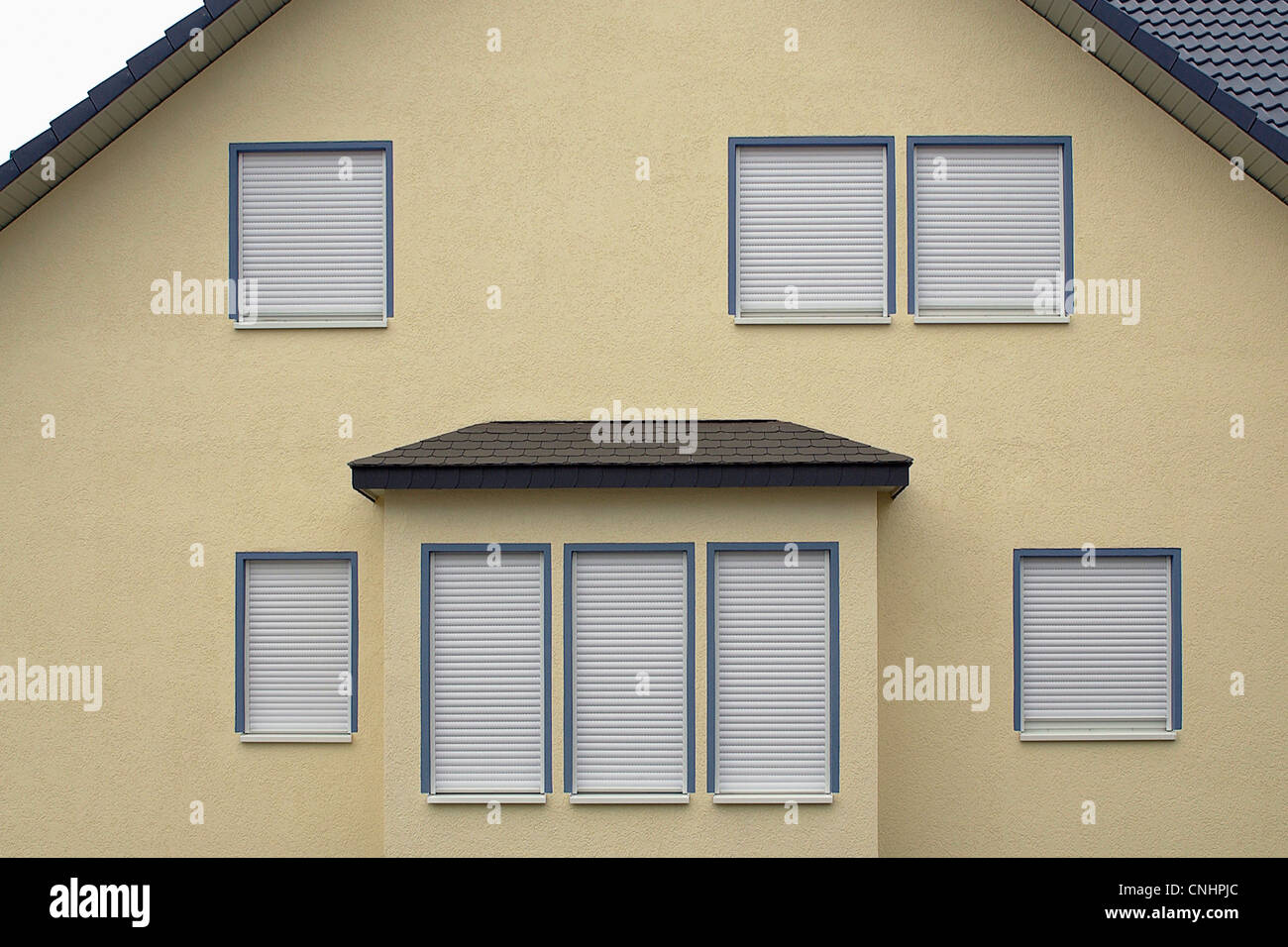 Side of house with window shutters down Stock Photo - Alamy