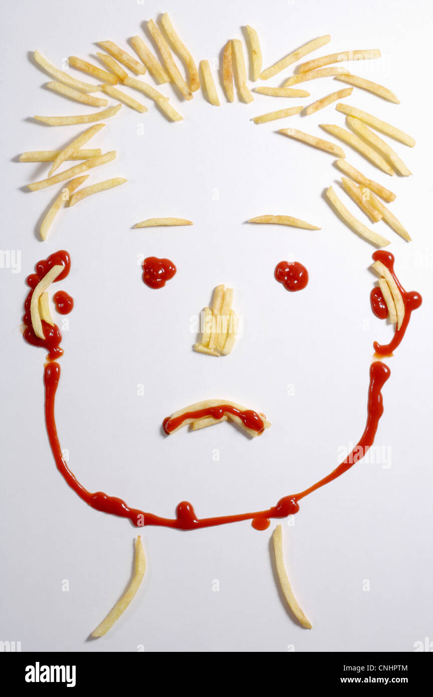 A sad face made from french fries and ketchup Stock Photo - Alamy