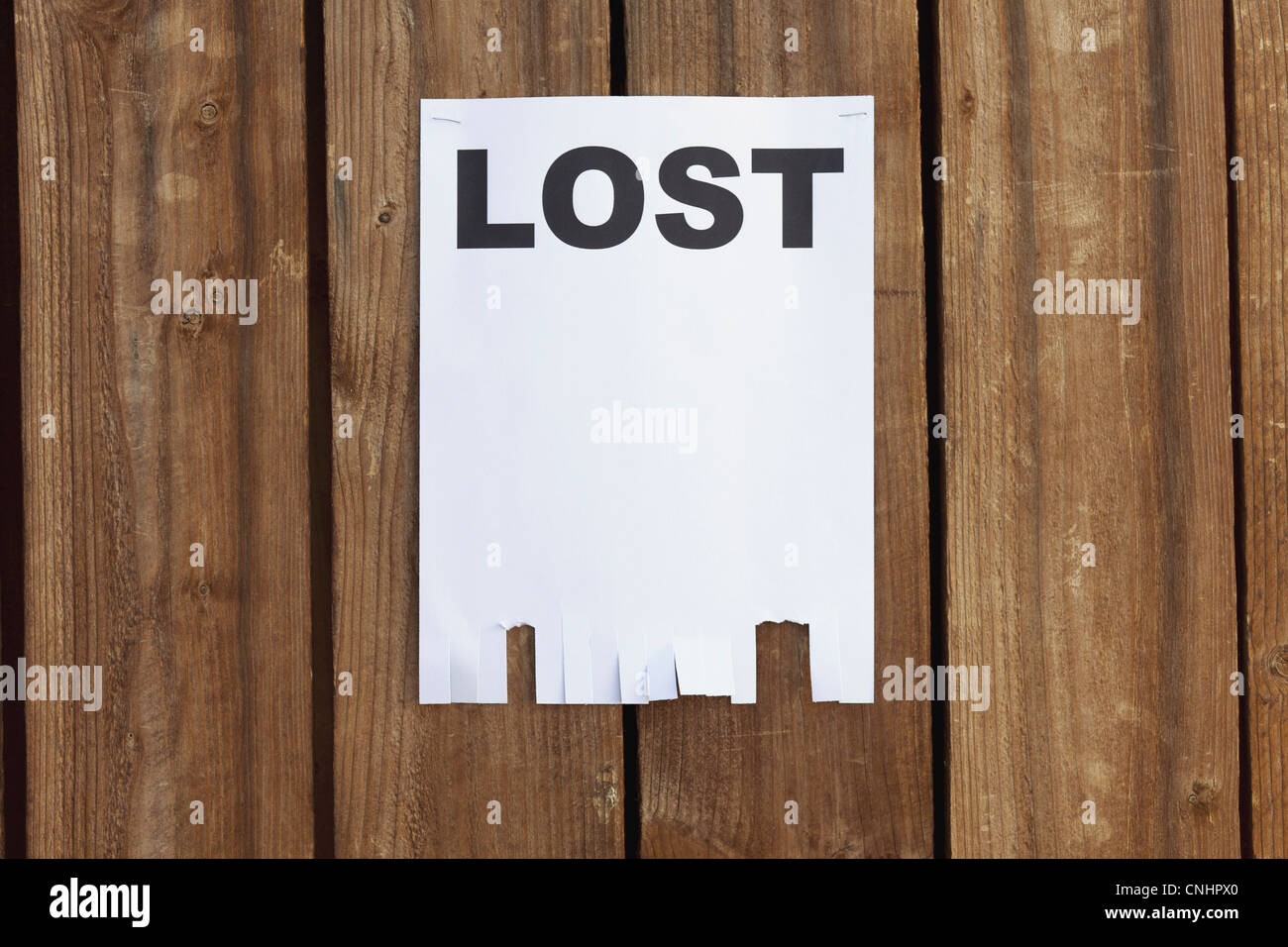 A flyer posted on a wooden fence with the word LOST on it Stock Photo ...