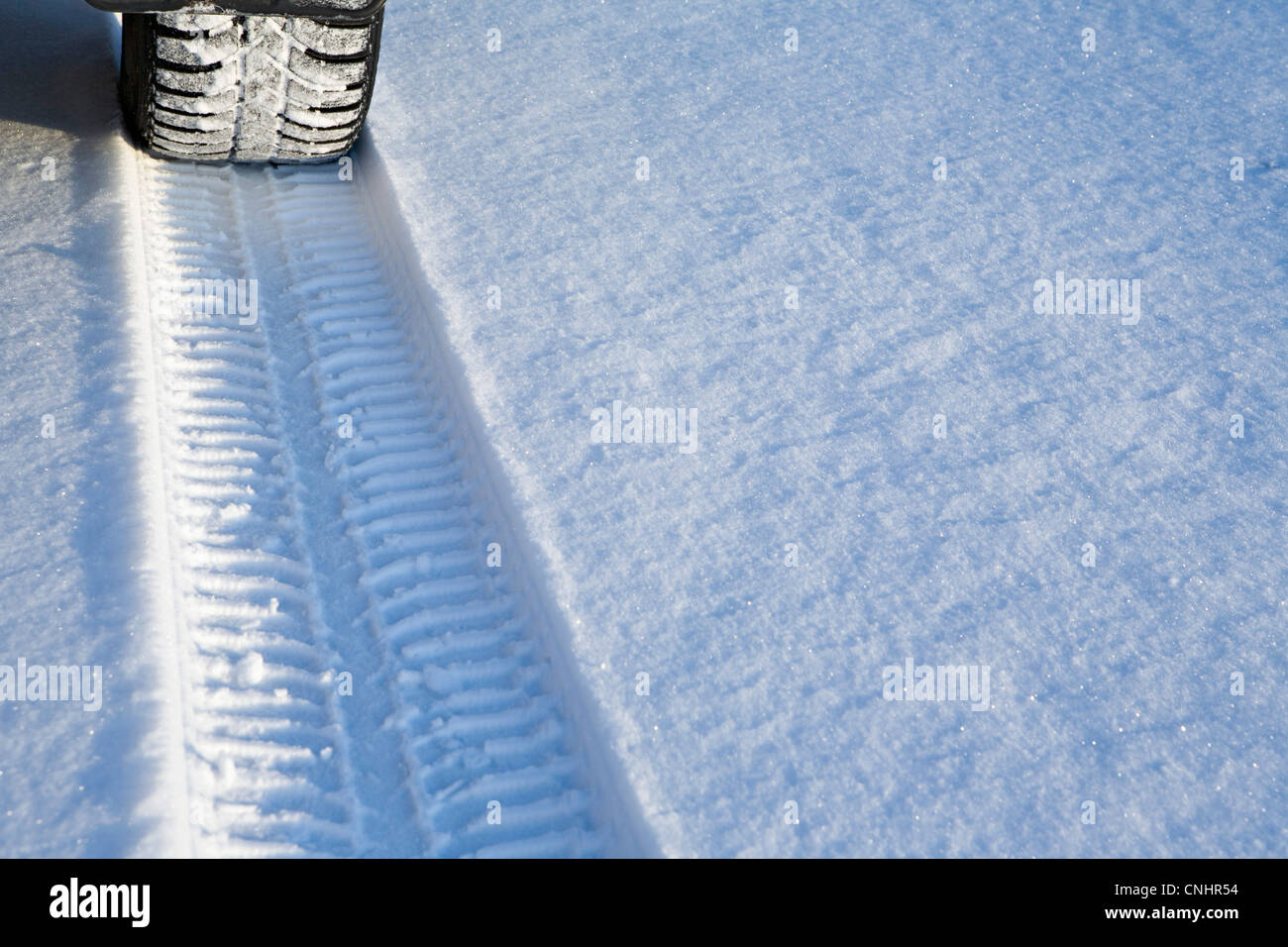 Tyre track on snow Stock Photo - Alamy