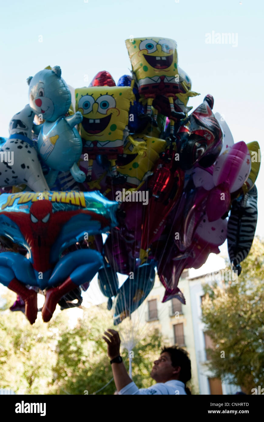 Man selling balloons in the street of Granada Stock Photo - Alamy