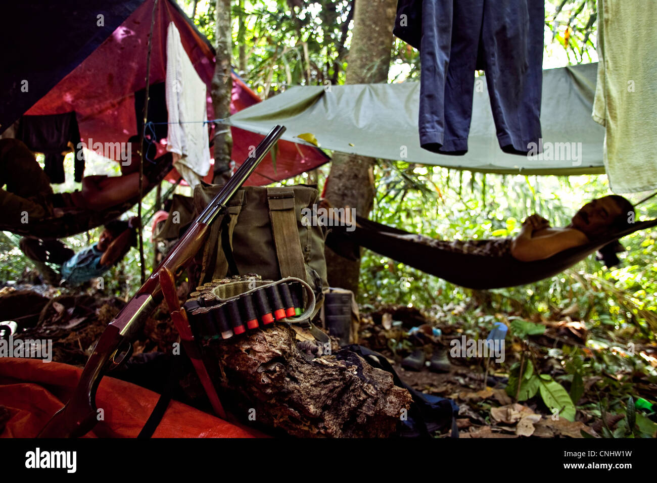 The hunters rest during the day in the camp in the jungle near Gubir in ...