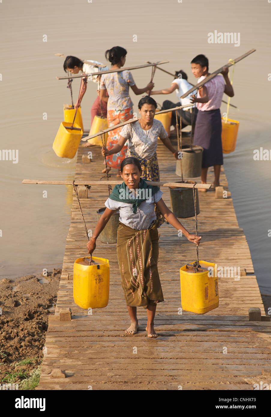 Collecting water from a reservoir between Mount Popa and Bagan Burma ...