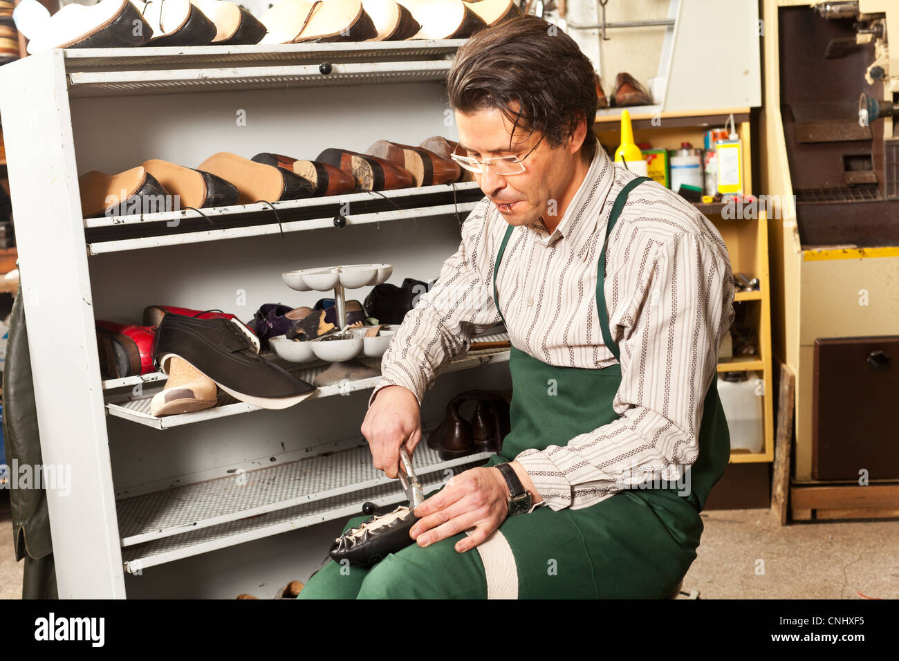 Shoemaker sits hi-res stock photography and images - Alamy