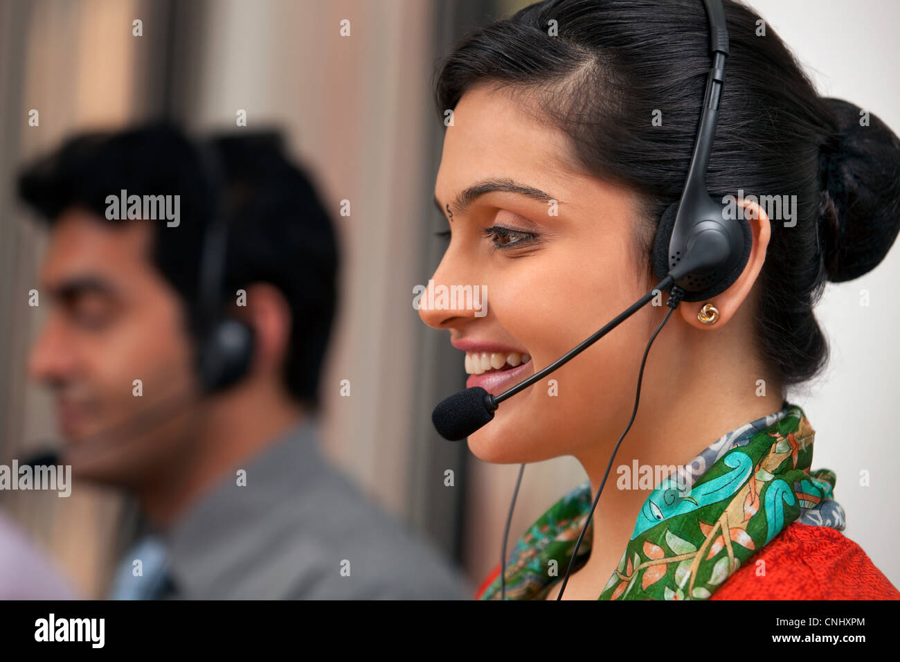 Female call center agent smiling Stock Photo - Alamy