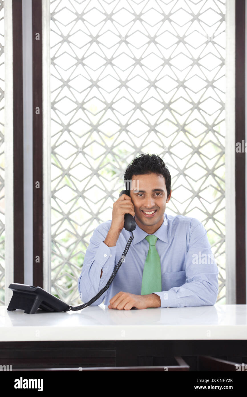 Portrait of executive talking on a phone Stock Photo - Alamy