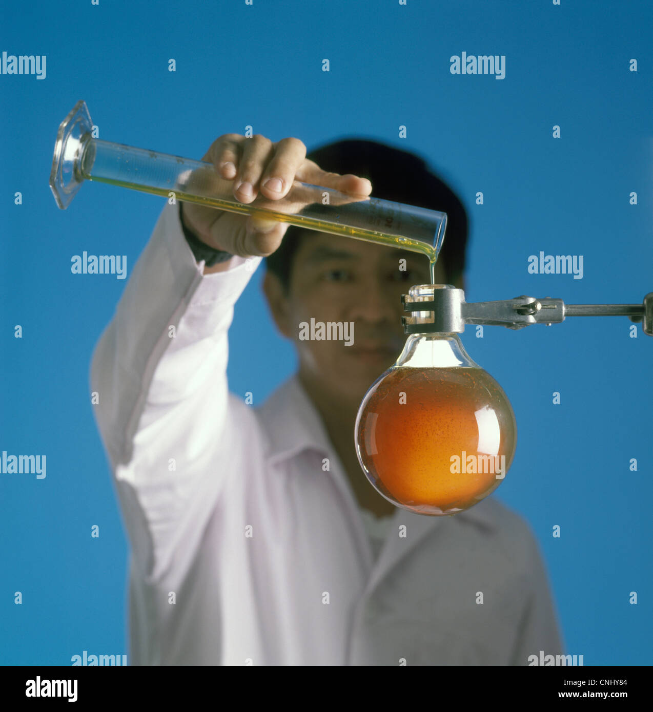 Lab assistant pouring chemicals Stock Photo - Alamy
