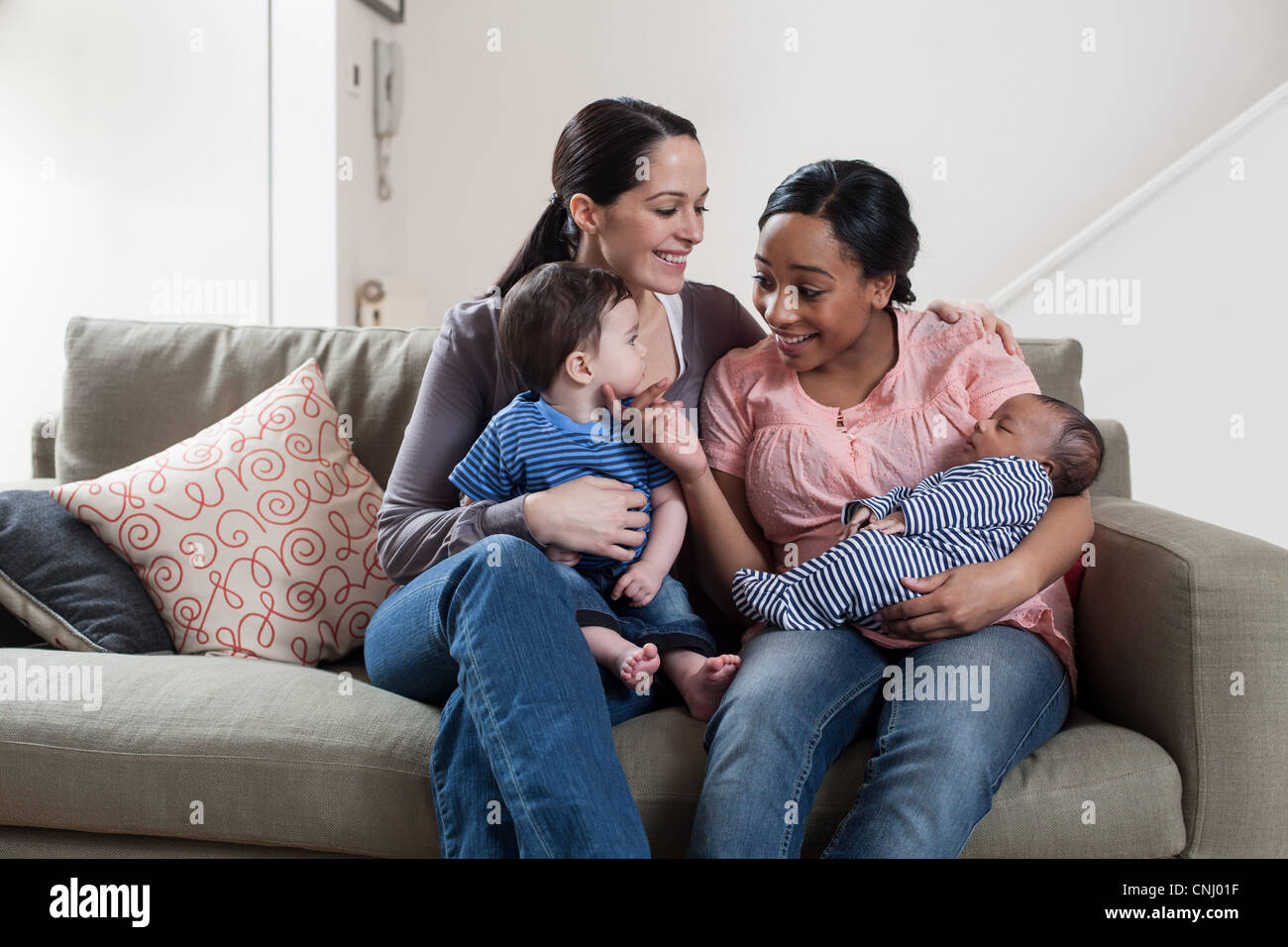 Two mothers with their babies Stock Photo - Alamy