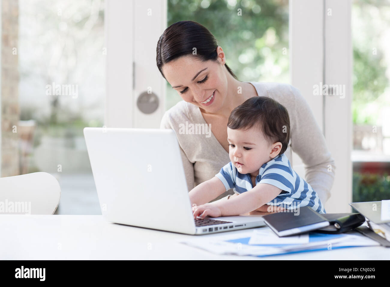 Mother and baby boy using laptop Stock Photo - Alamy