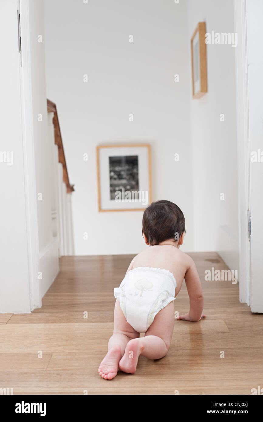 Baby crawling near stairs Stock Photo - Alamy